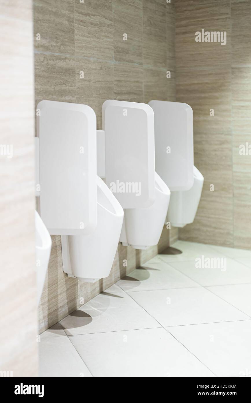 Row of urinals in public restroom Stock Photo - Alamy