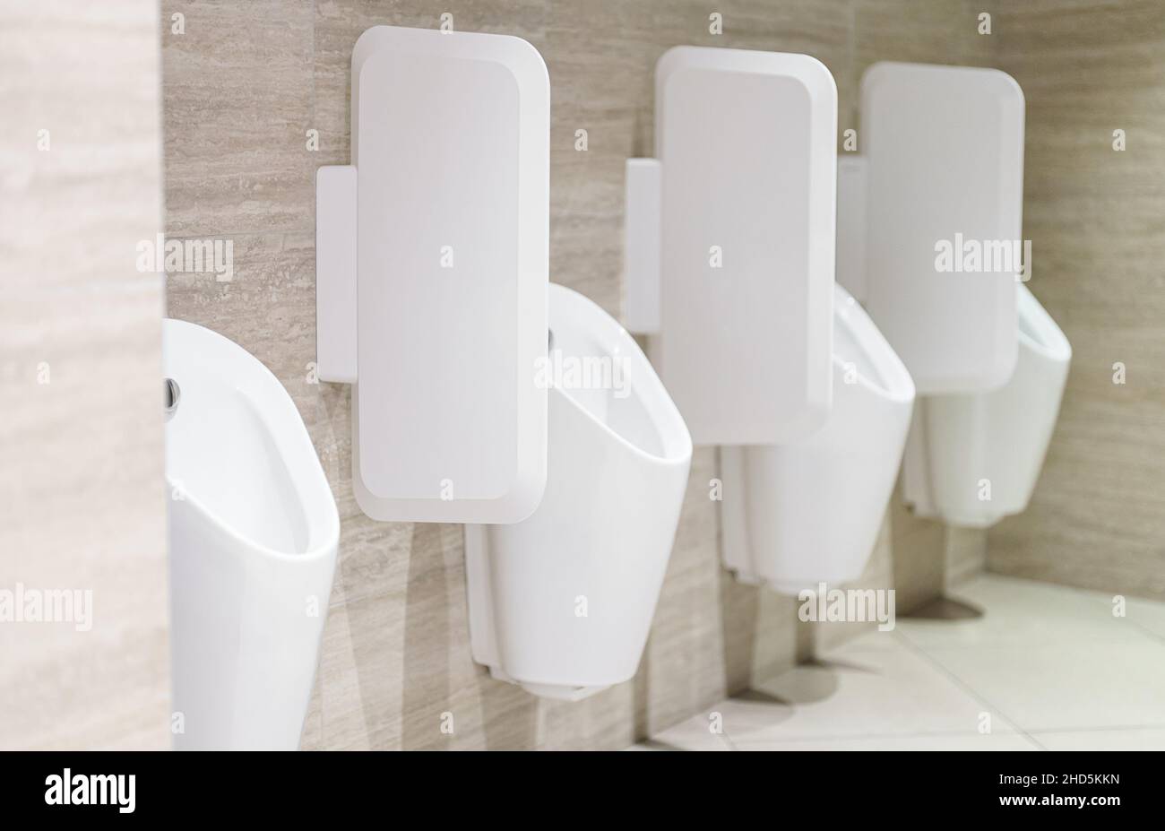 Row of urinals in public restroom Stock Photo - Alamy