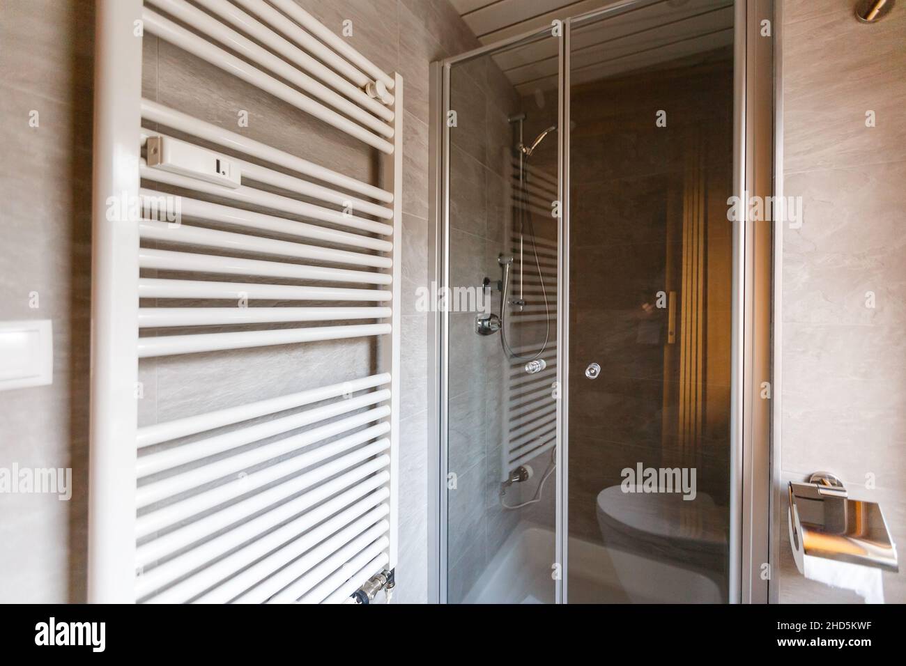 Modern spacious bathroom with bright tiles with toilet and sink. Side ...