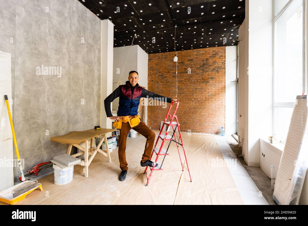 Builder handyman with construction tools. House renovation background ...