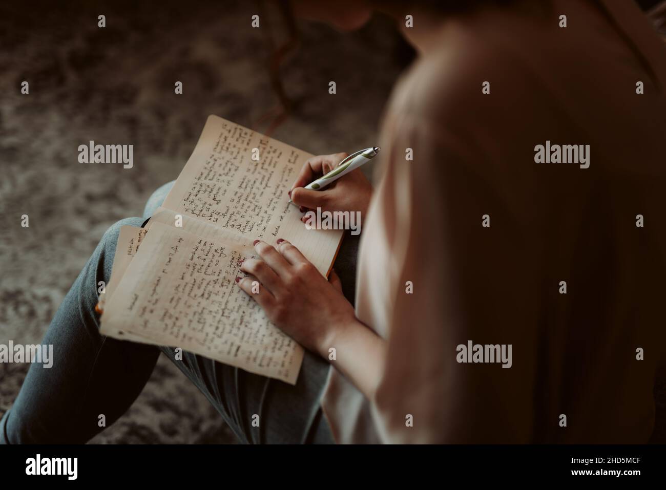 Female writing a text in a noteboo Stock Photo - Alamy