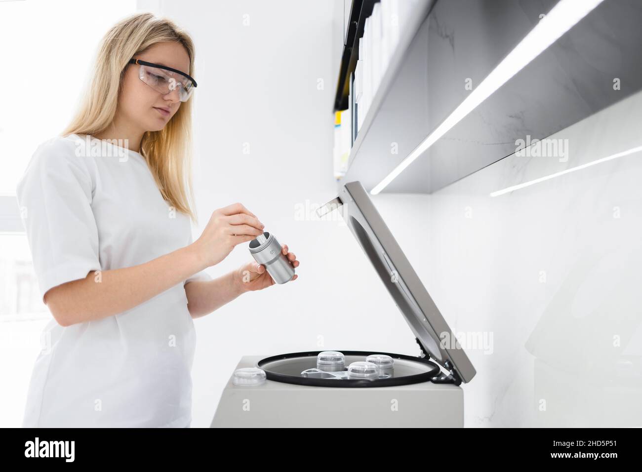 Female doctor hands putting test tube to metal container. Plasmolifting ...
