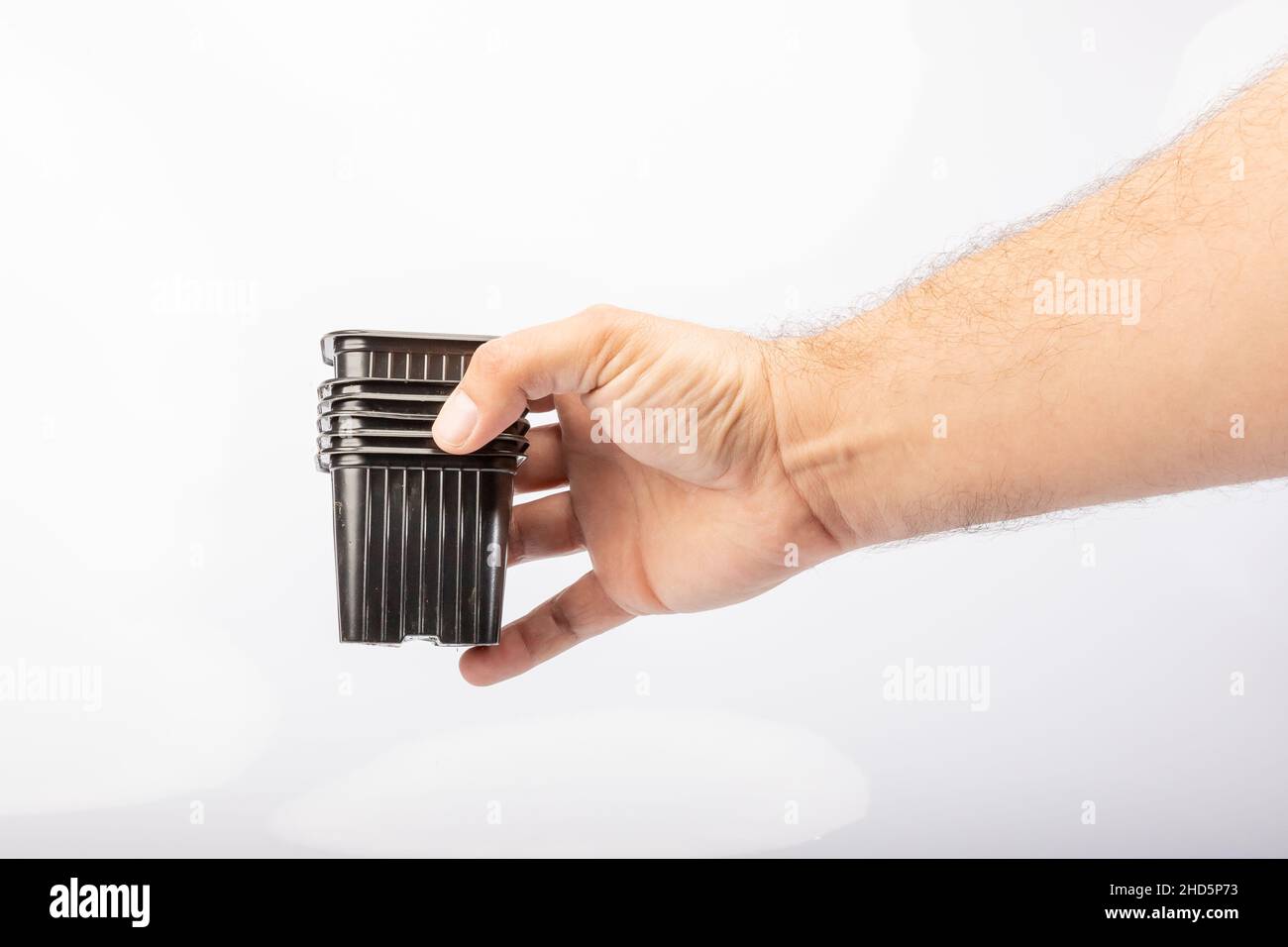hand holding planting pots on white background in studio Stock Photo ...