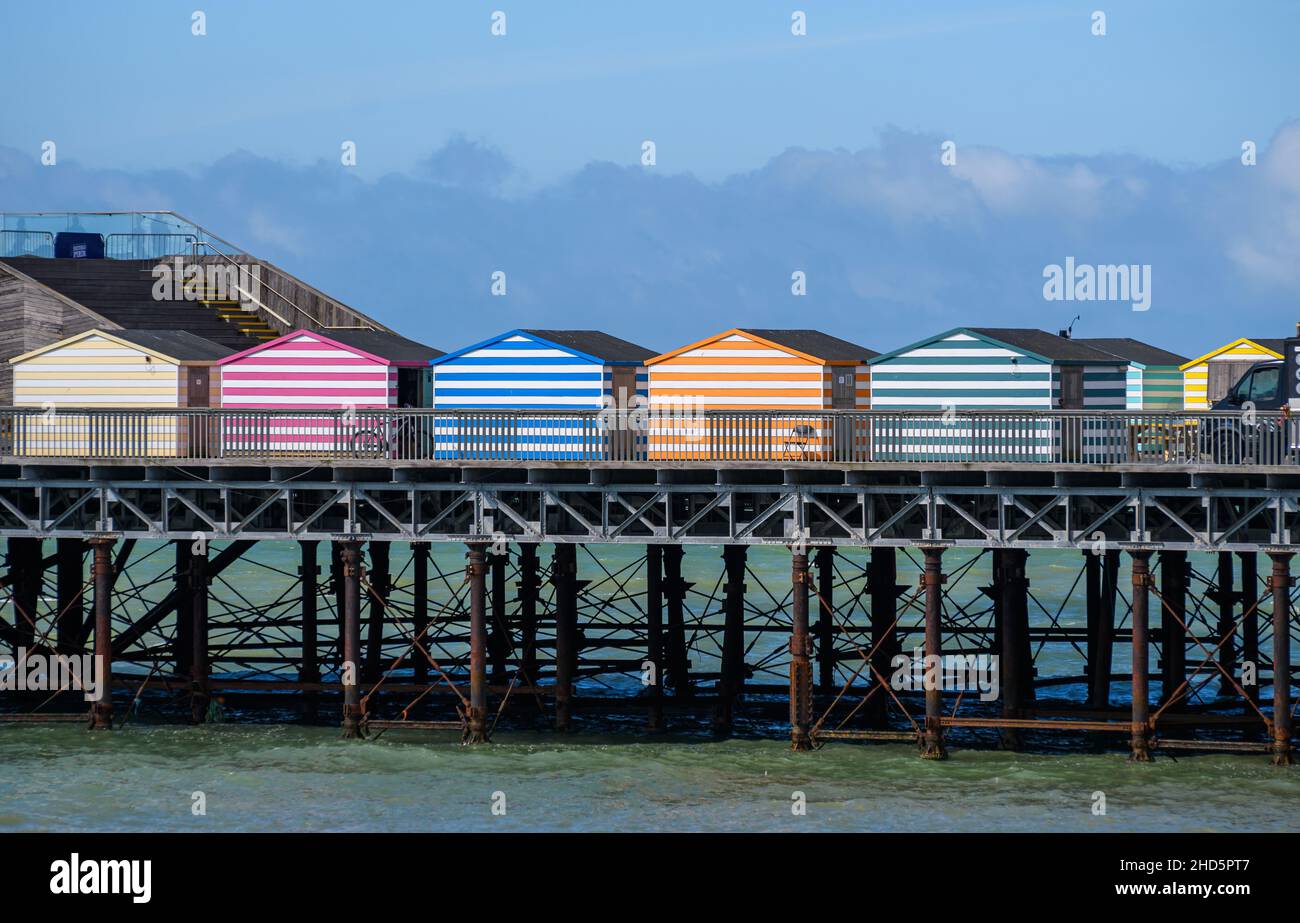 A line of colourful beach huts on Hastings Pier Stock Photo - Alamy