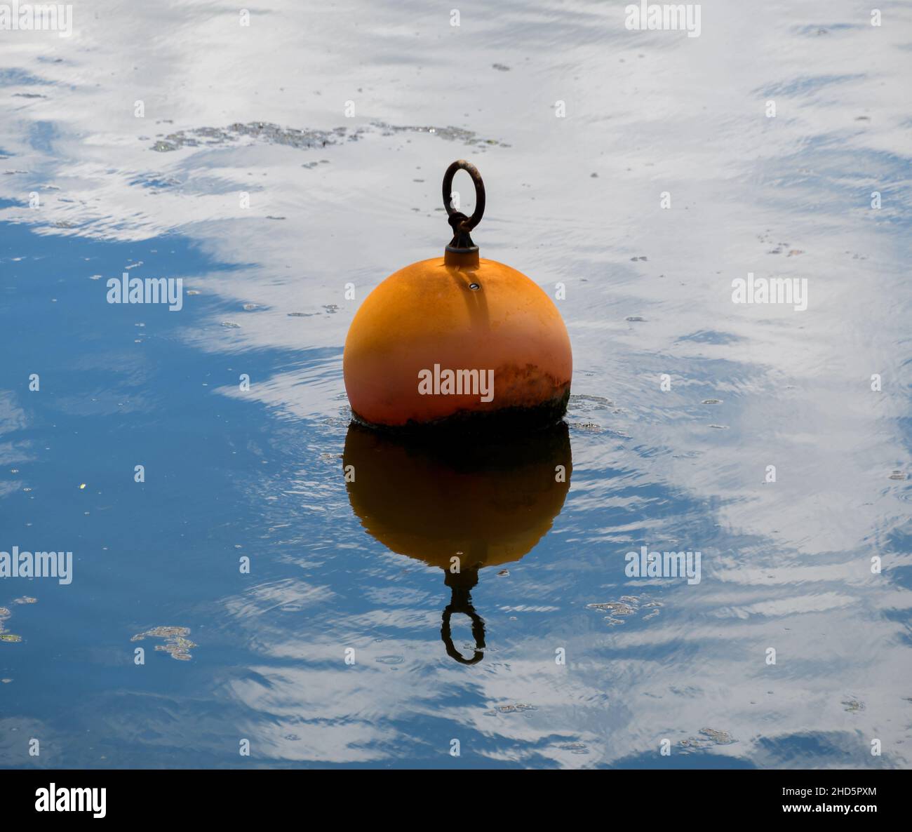 An orange buoy floating in the waters of Aberaeron harbour Stock Photo ...