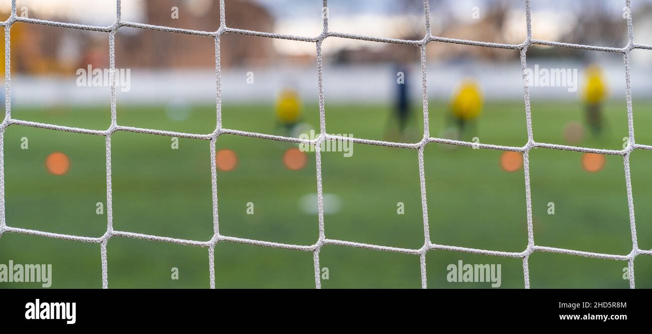 Soccer goal background with defocused green field. Closeup view, detail ...
