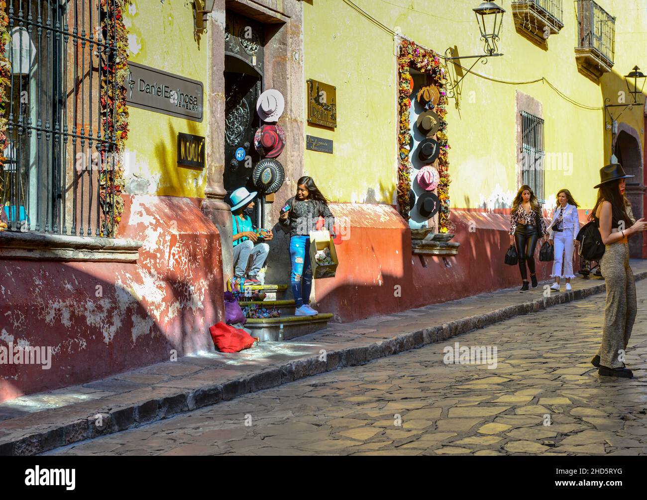 Street vendors hawk their wares on cobblestone streets to Shoppers and ...