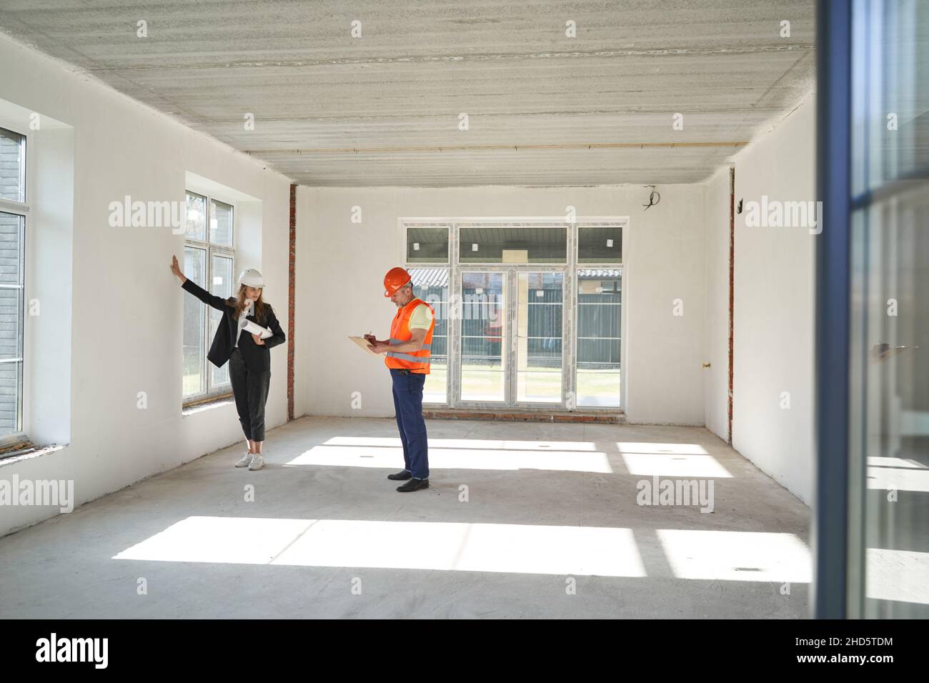 Construction worker making notes of engineer instructions Stock Photo ...