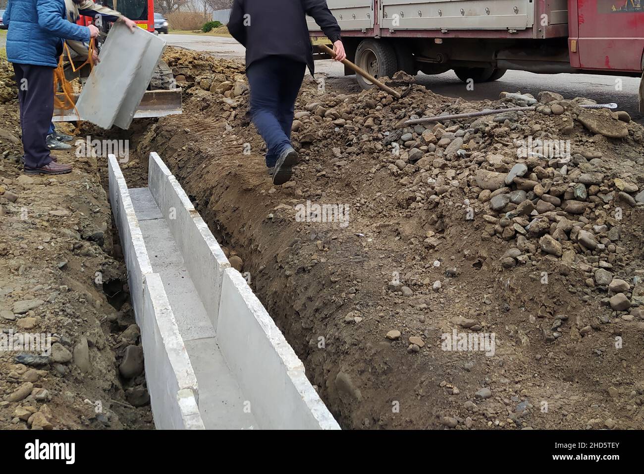 Dolyna , Ukraine November 22, 2021: The excavator installs concrete ...