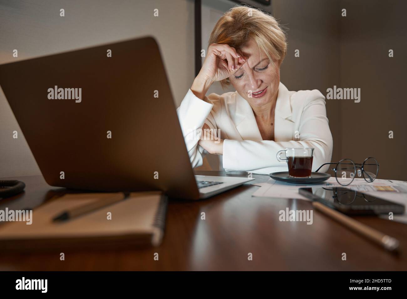 Tired businesswoman overworking in hotel room at night Stock Photo - Alamy