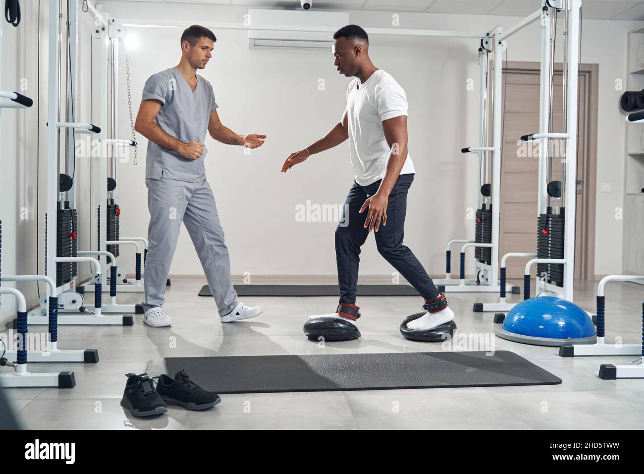 Focused guy using training device during stability workout Stock Photo ...