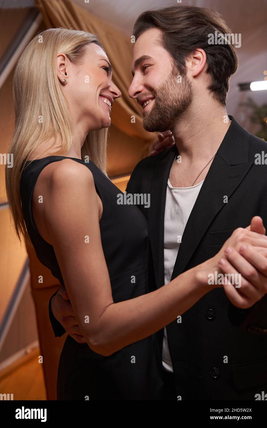 Caucasian man staring at female with smile during dance Stock Photo - Alamy