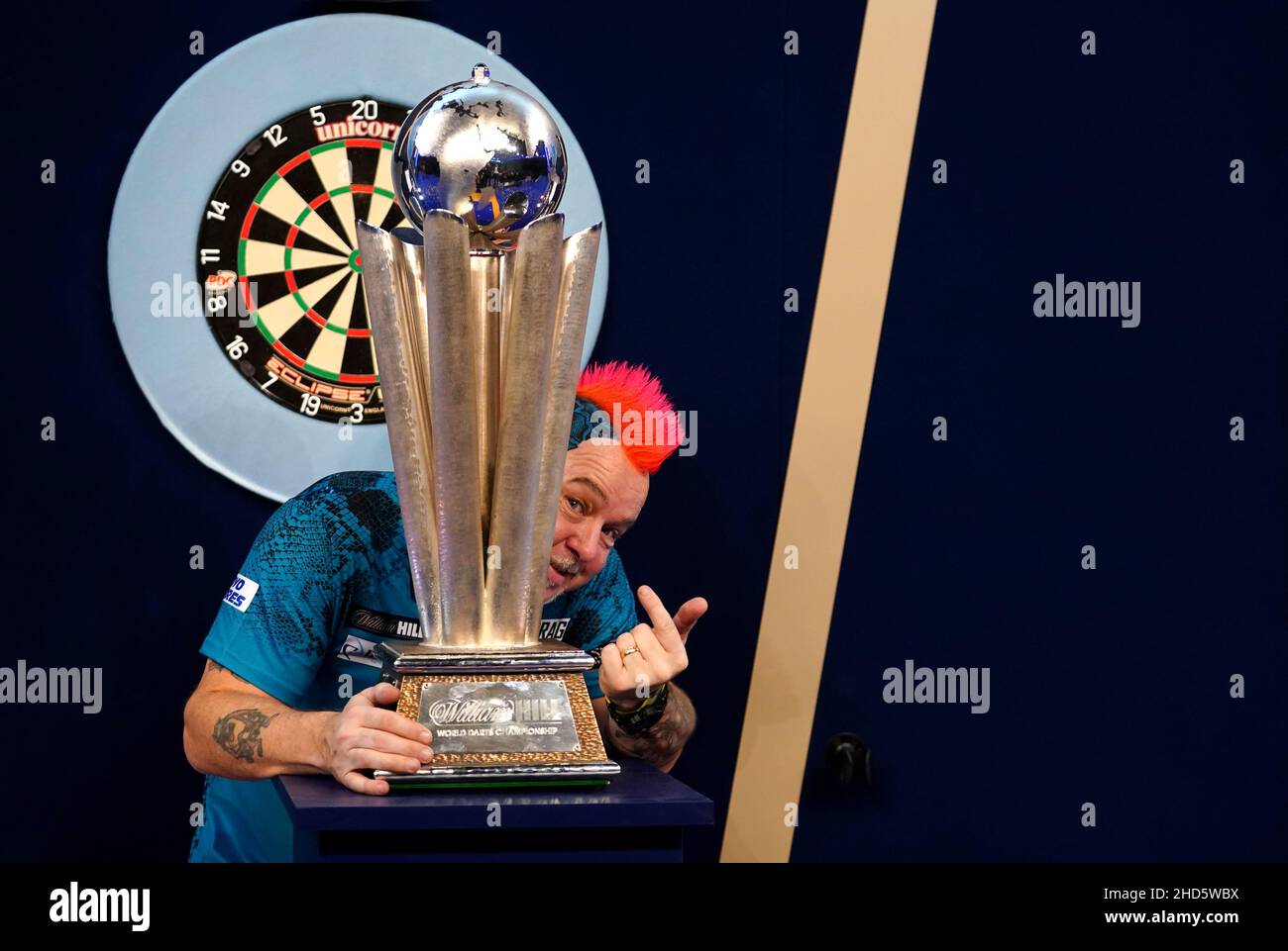 Peter Wright celebrates with the Sid Waddell Trophy after victory ...