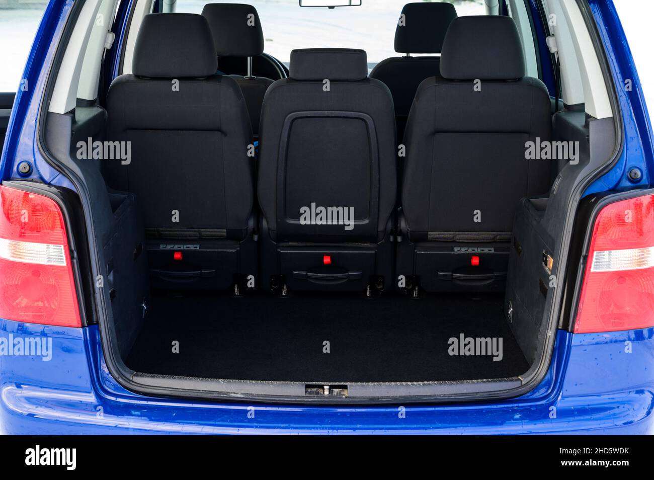 Minivan trunk with rear seats. Blue car, trunk in the car and its ...