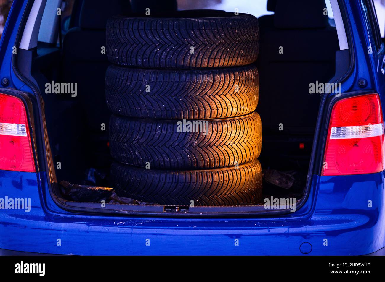 Set of all-season tires in the trunk of the car, four interchangeable ...