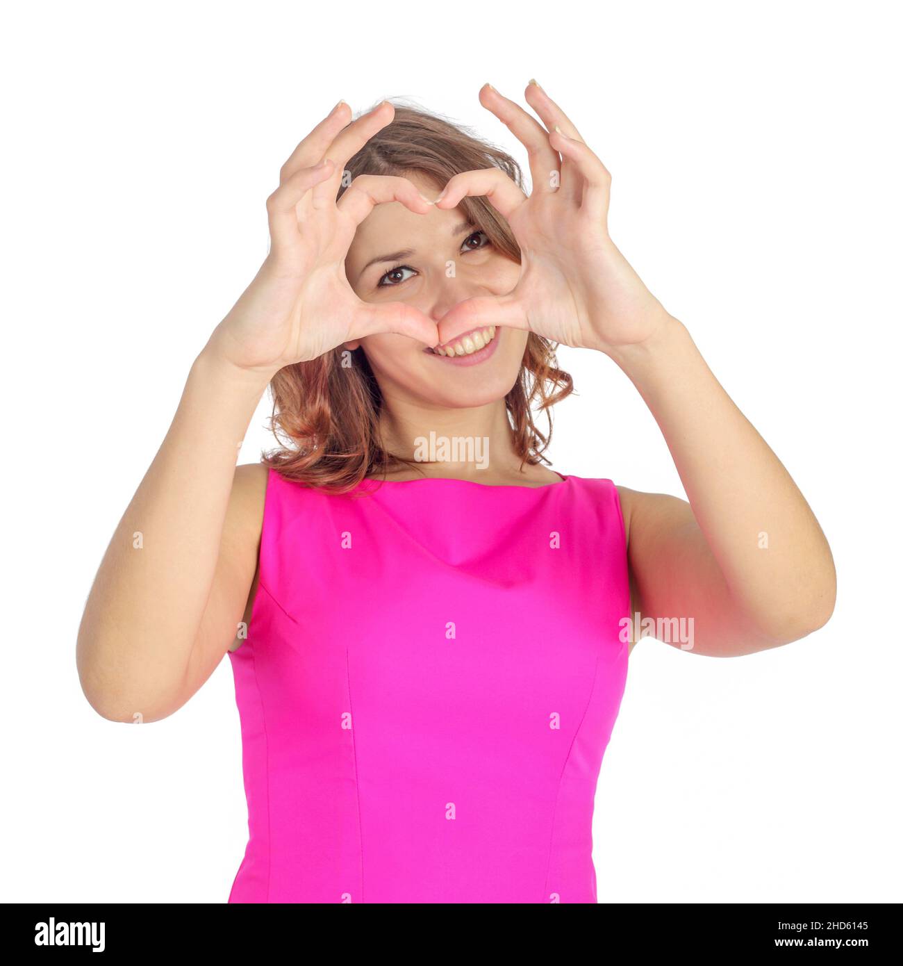 pretty young girl making a heart symbol with her hands, focus on the ...