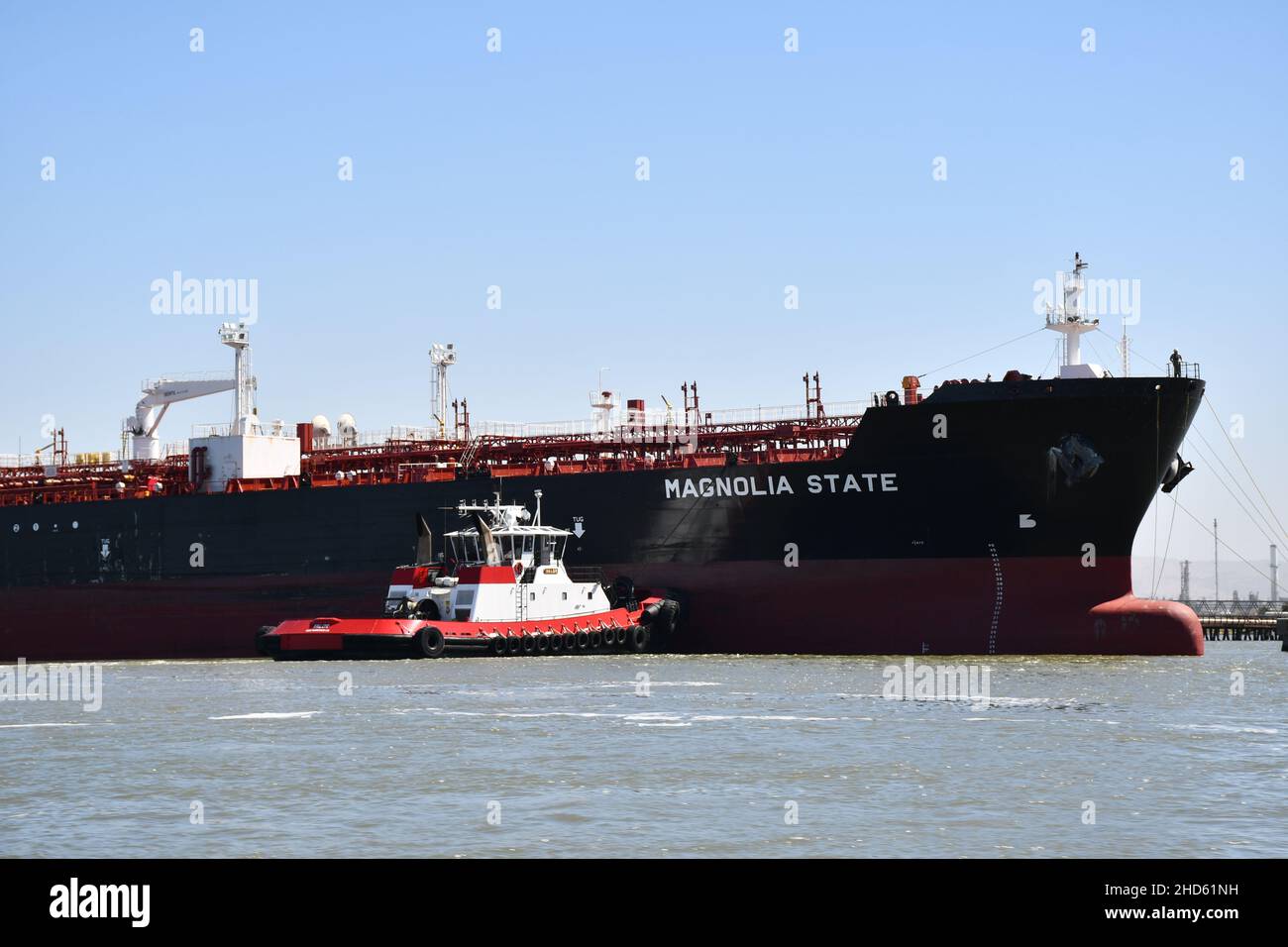 Tug docking bulk freighter Magnolia State. Commercial freight and ...