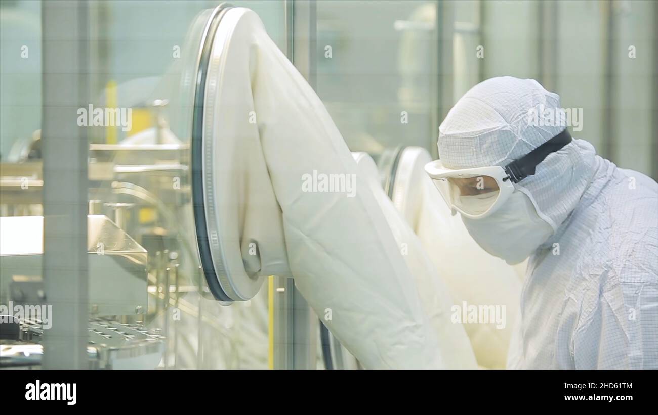 Pharmaceutics. Pharmaceutical worker operates blister packaging machine ...
