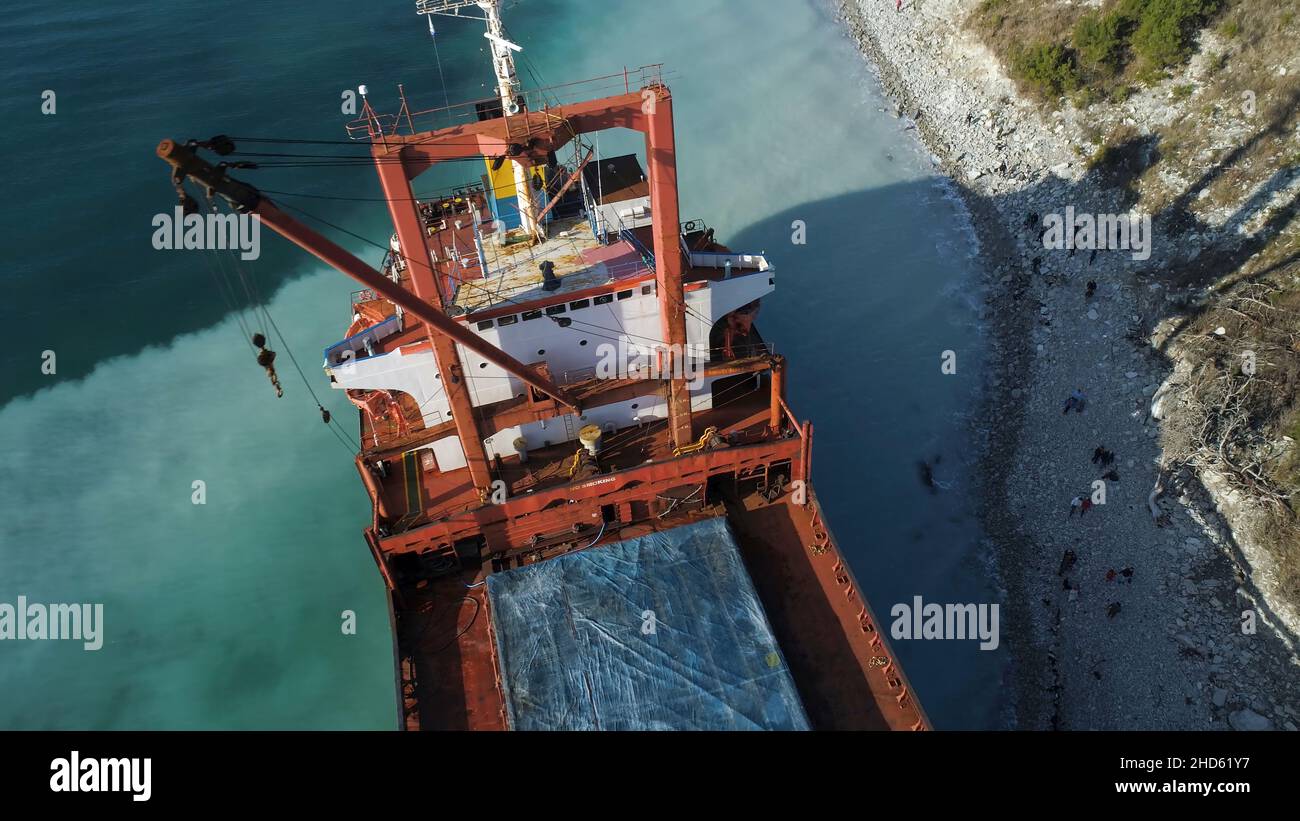 Aerial top view of an empty, red barge moored near the beautiful blue ...