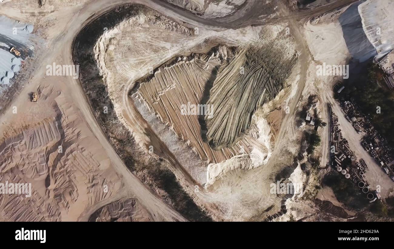 Aerial top view of quarry during work hours. Industrial background with ...