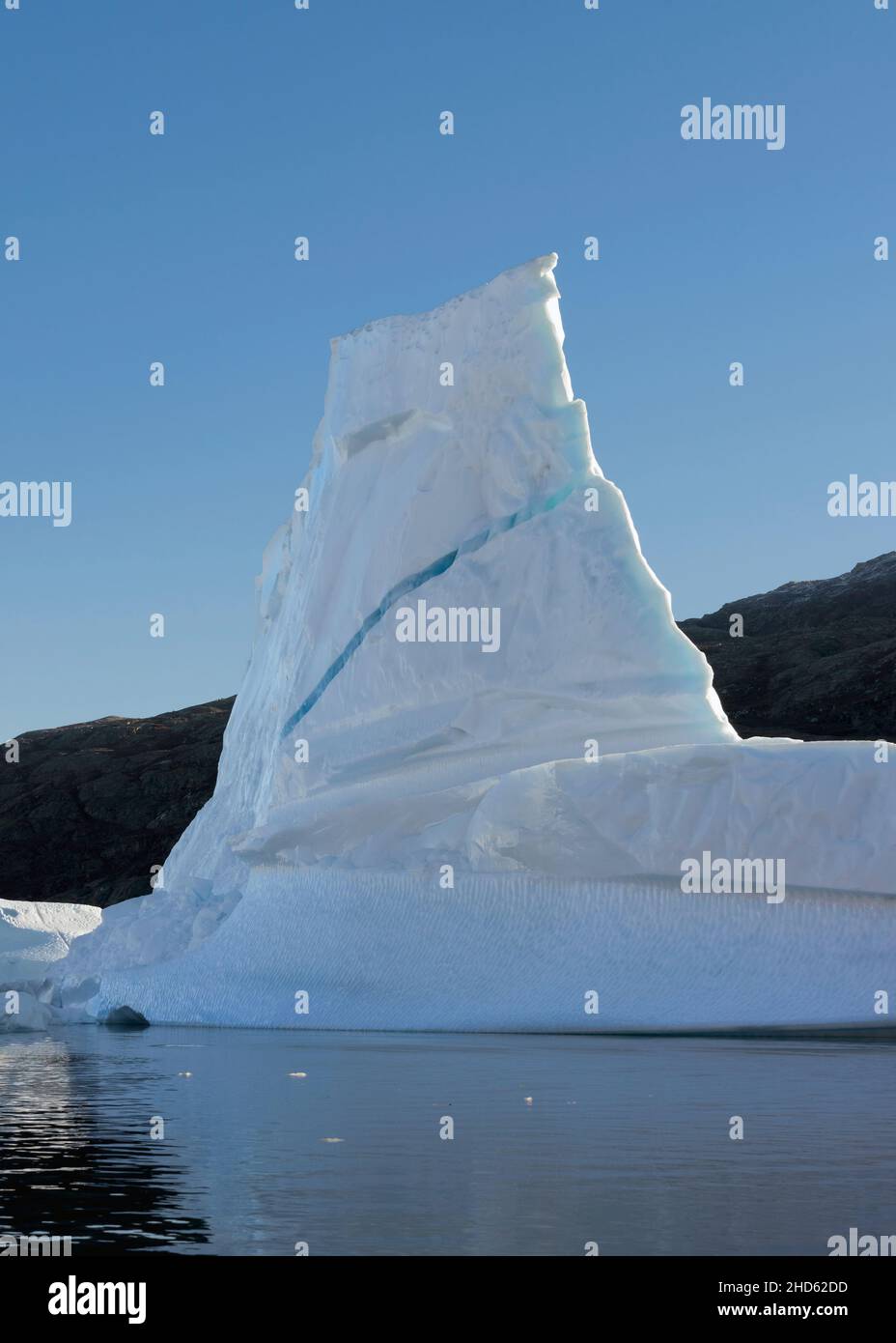 Backlit iceberg tower with blue streak, Rodefjord, Scoresby Sund ...
