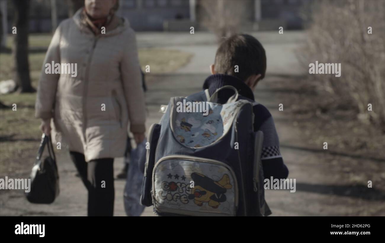 Little boy with a backpack go to school. Back view. Boy with a backpack ...
