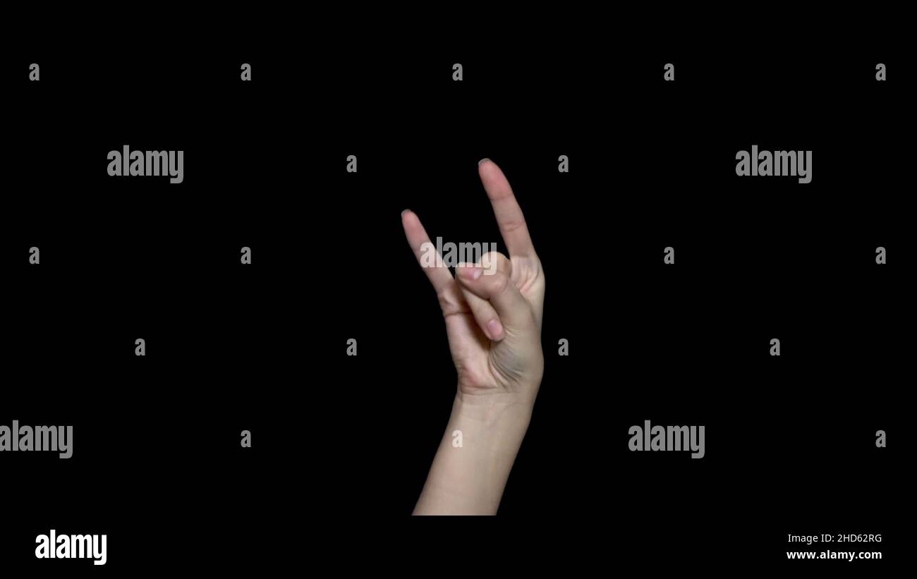 Female hand showing rock anf roll sign or three fingers in front of ...