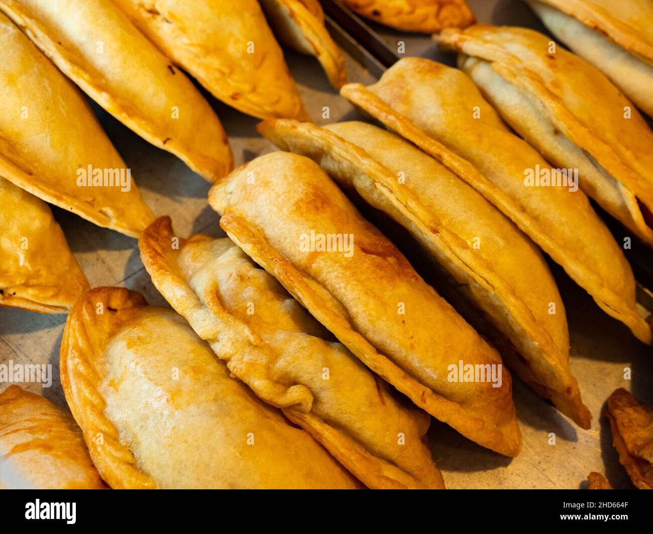 Baked snack empanada at market Stock Photo - Alamy