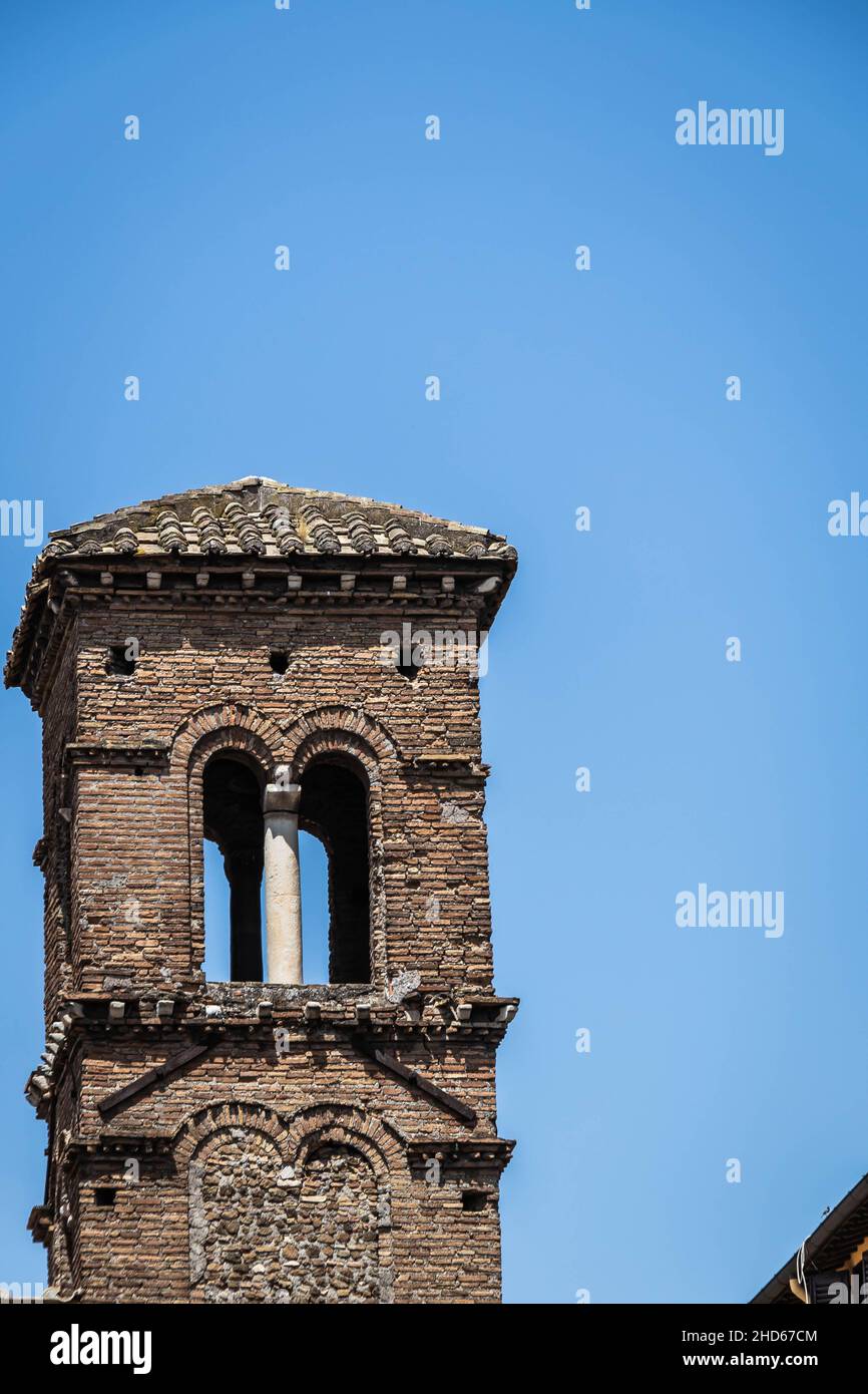 The eroding stonework of an old church bell tower in Rome against a ...