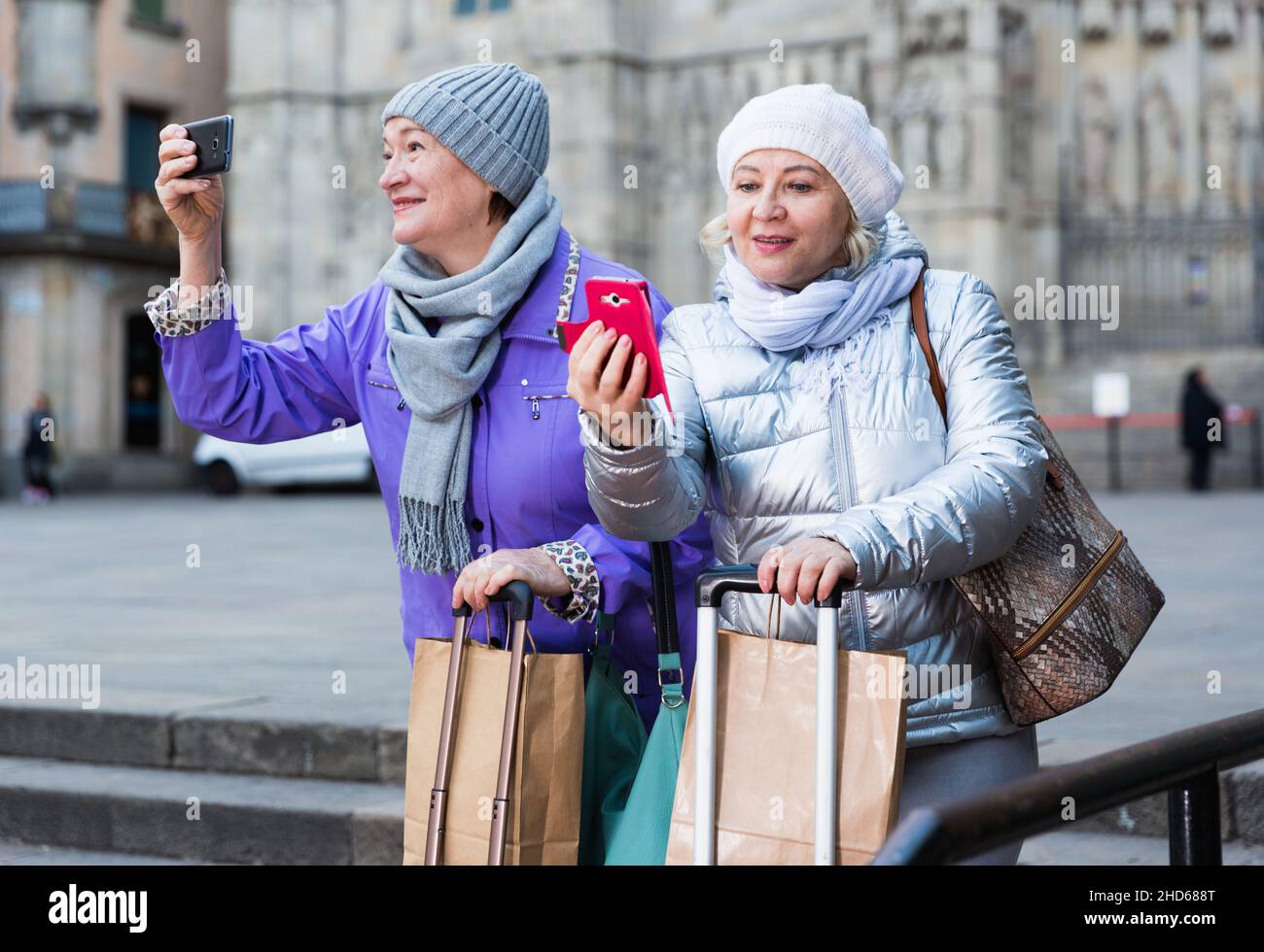 Senior women photographing city attractions Stock Photo - Alamy
