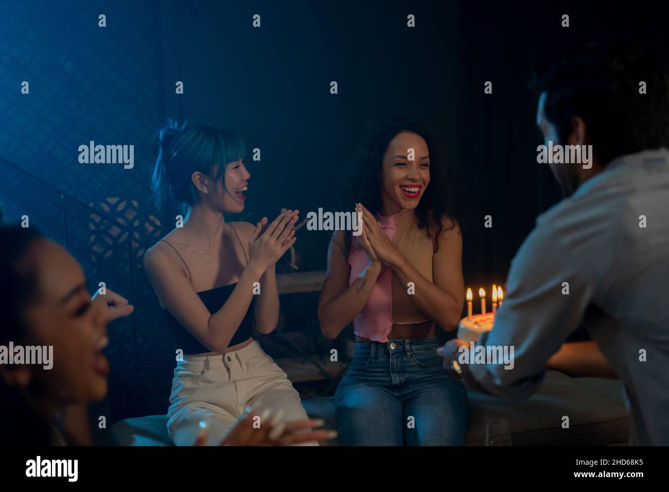 Portrait of cheerful woman laughing and clapping while man presenting ...