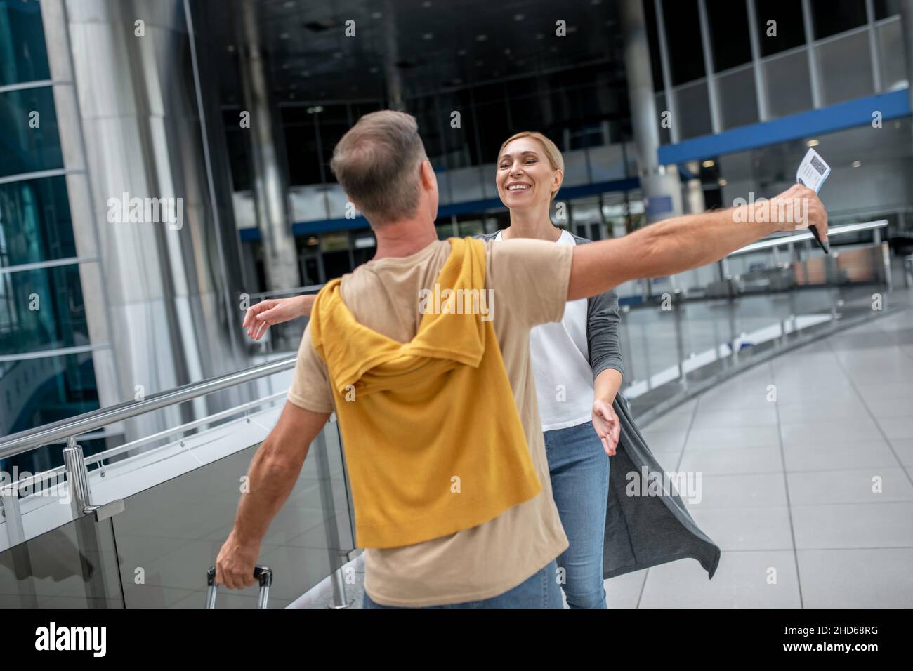 Delighted beautiful woman welcoming her male guest Stock Photo - Alamy