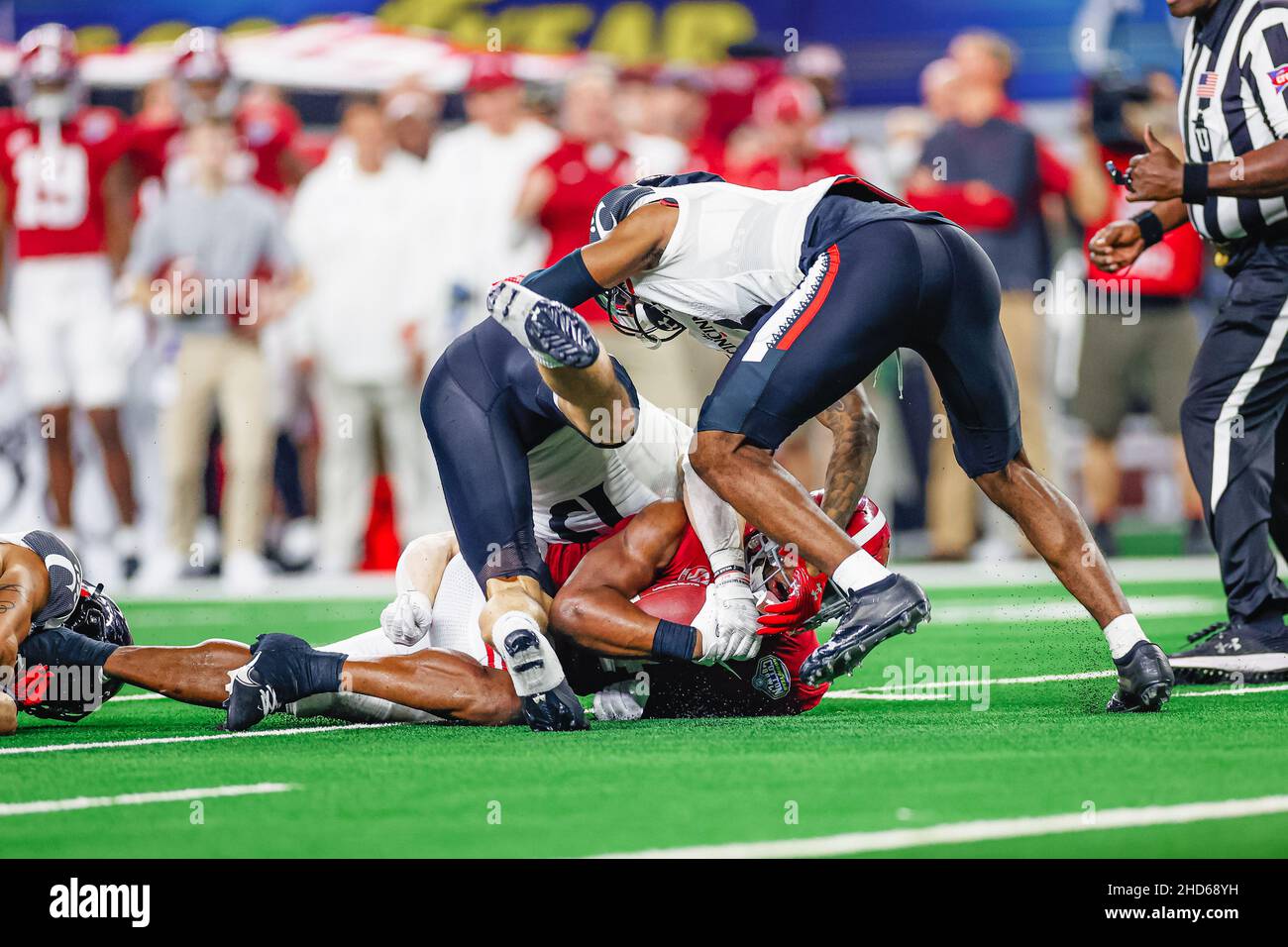 Cincinnati Bearcats defensive players make a tackle on Alabama Crimson ...