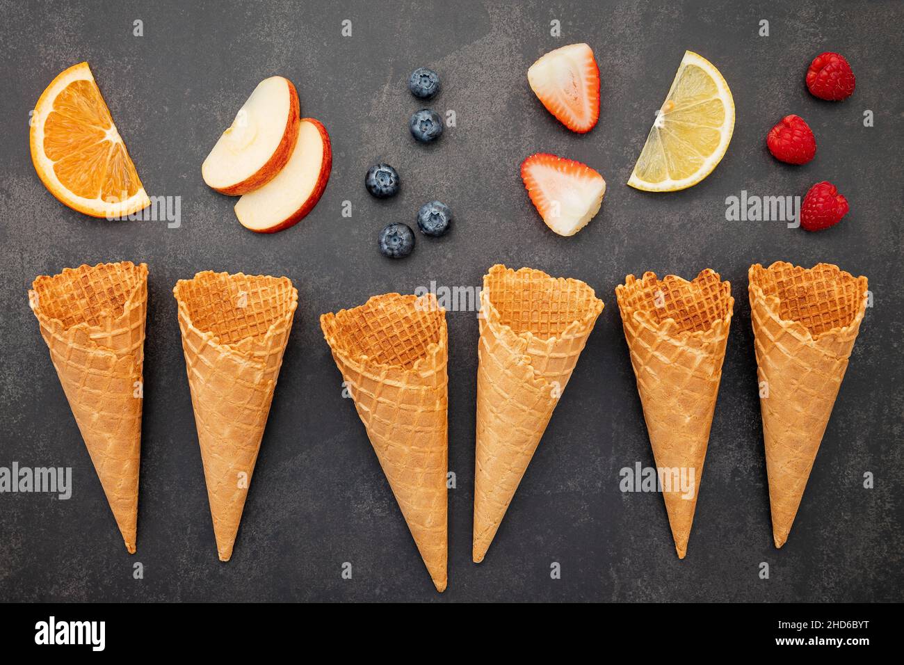 Flat lay ice cream cones collection on dark stone background . Blank ...