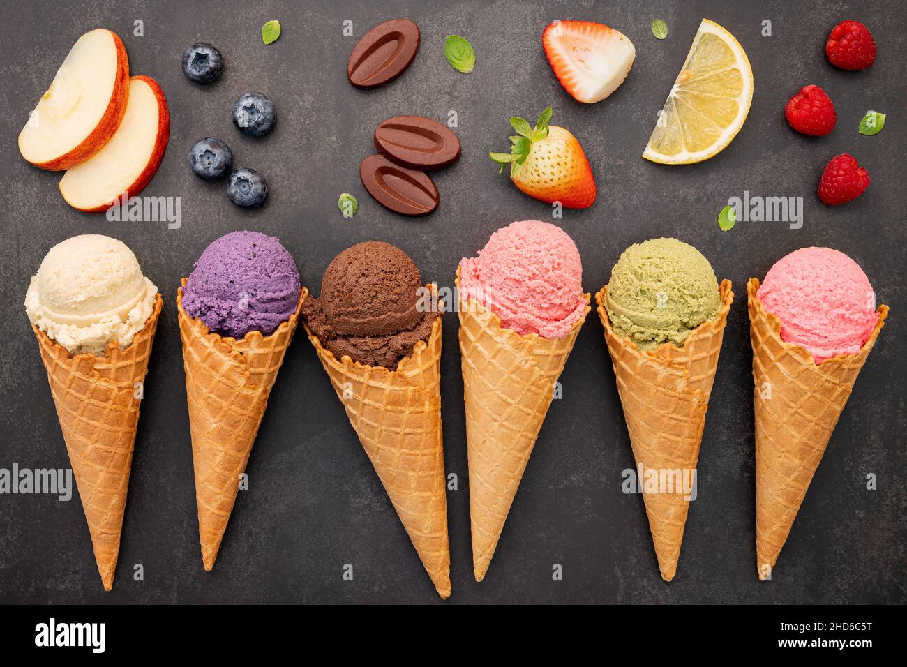 Flat lay ice cream cones collection on dark stone background . Blank ...