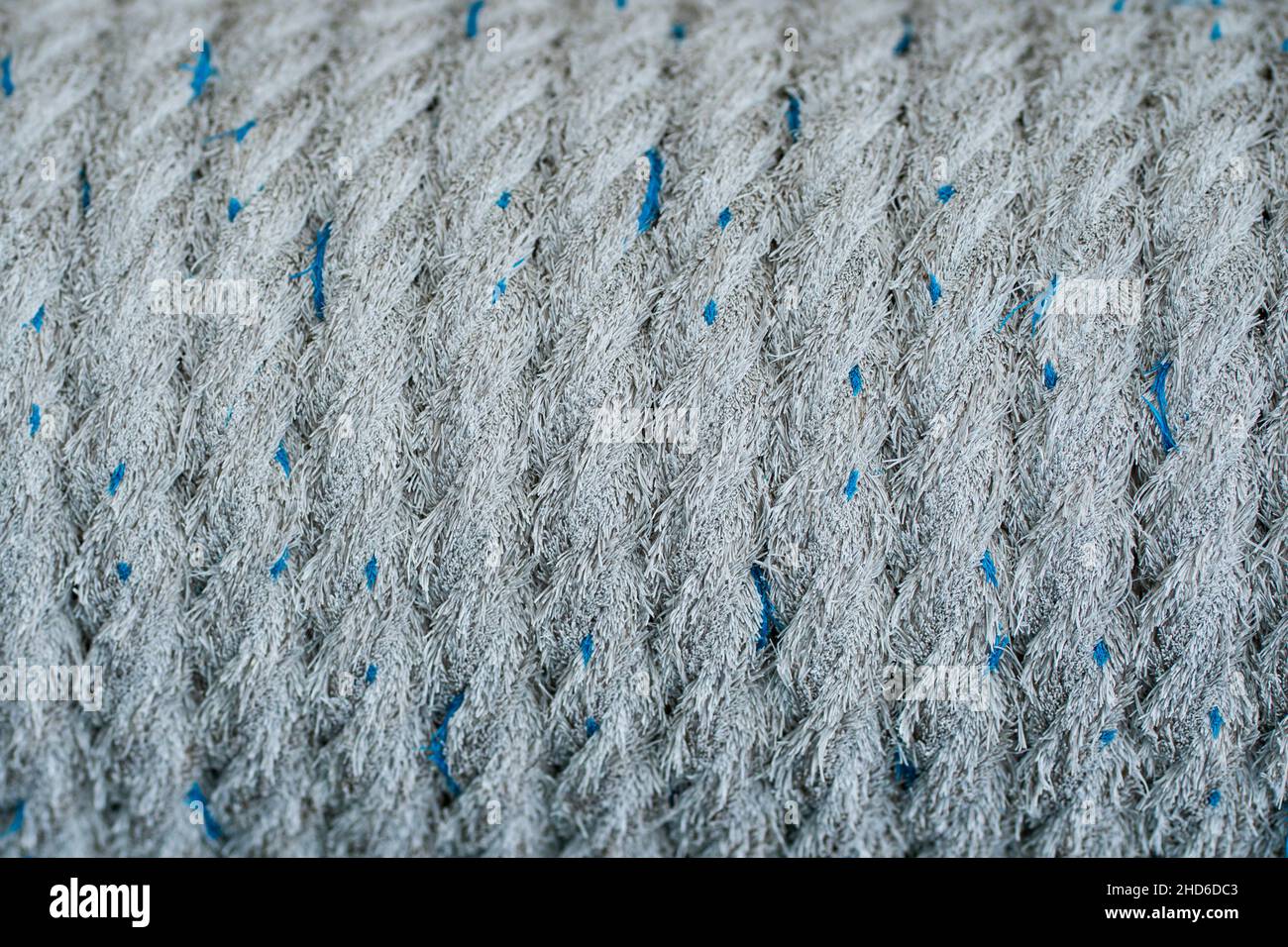 Close up of the fiber rope wound up tightly with speckled of blue ...