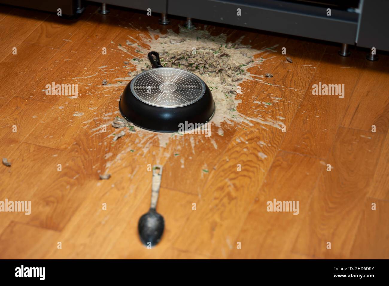 a turned over food on the floor of a kitchen, tilt shift indoor shot ...