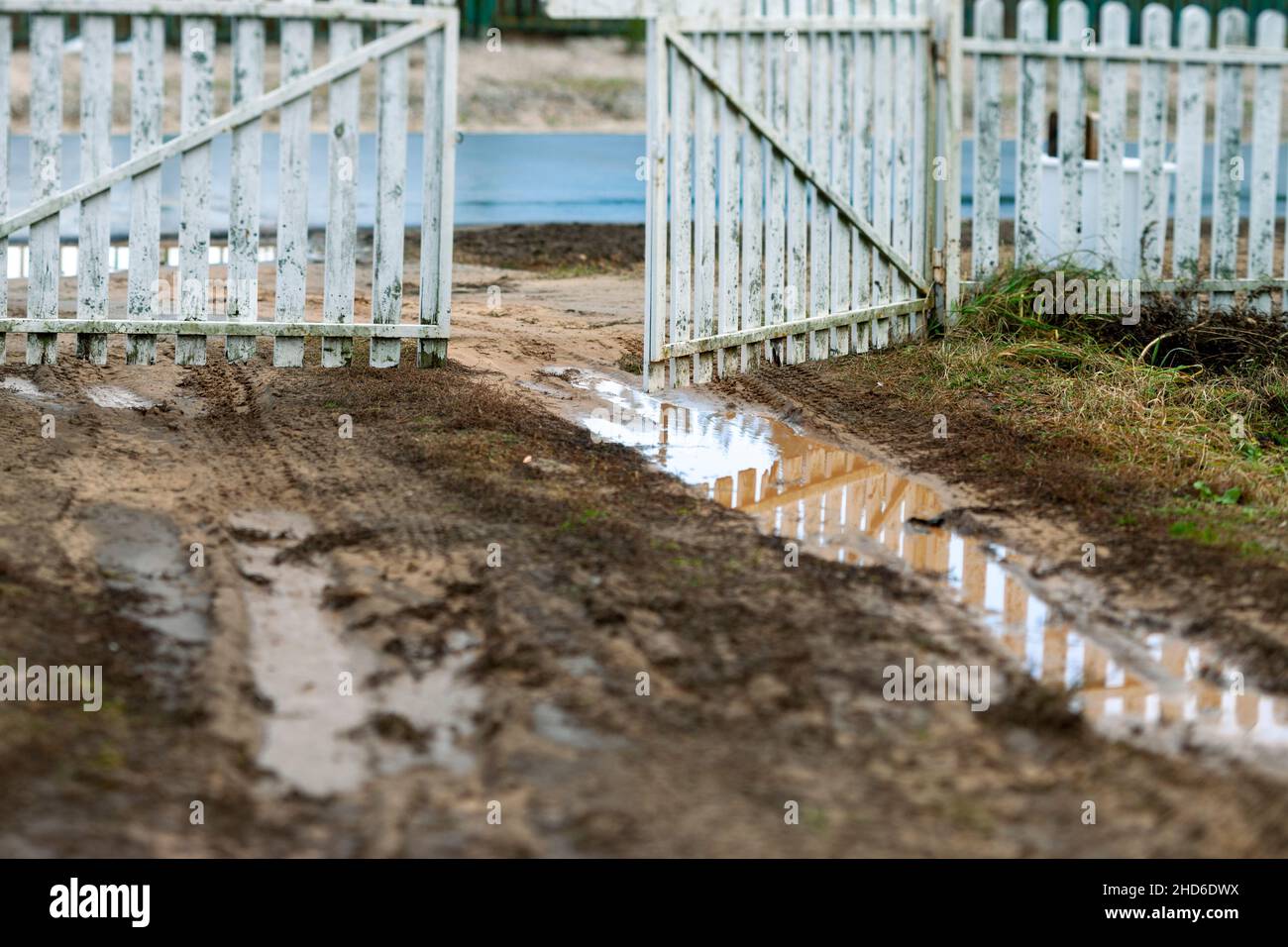 messy road and half open wooden gate, autumn daylight shot Stock Photo ...