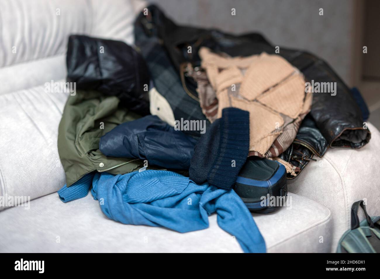 Messy clothes on sofa hi-res stock photography and images - Alamy