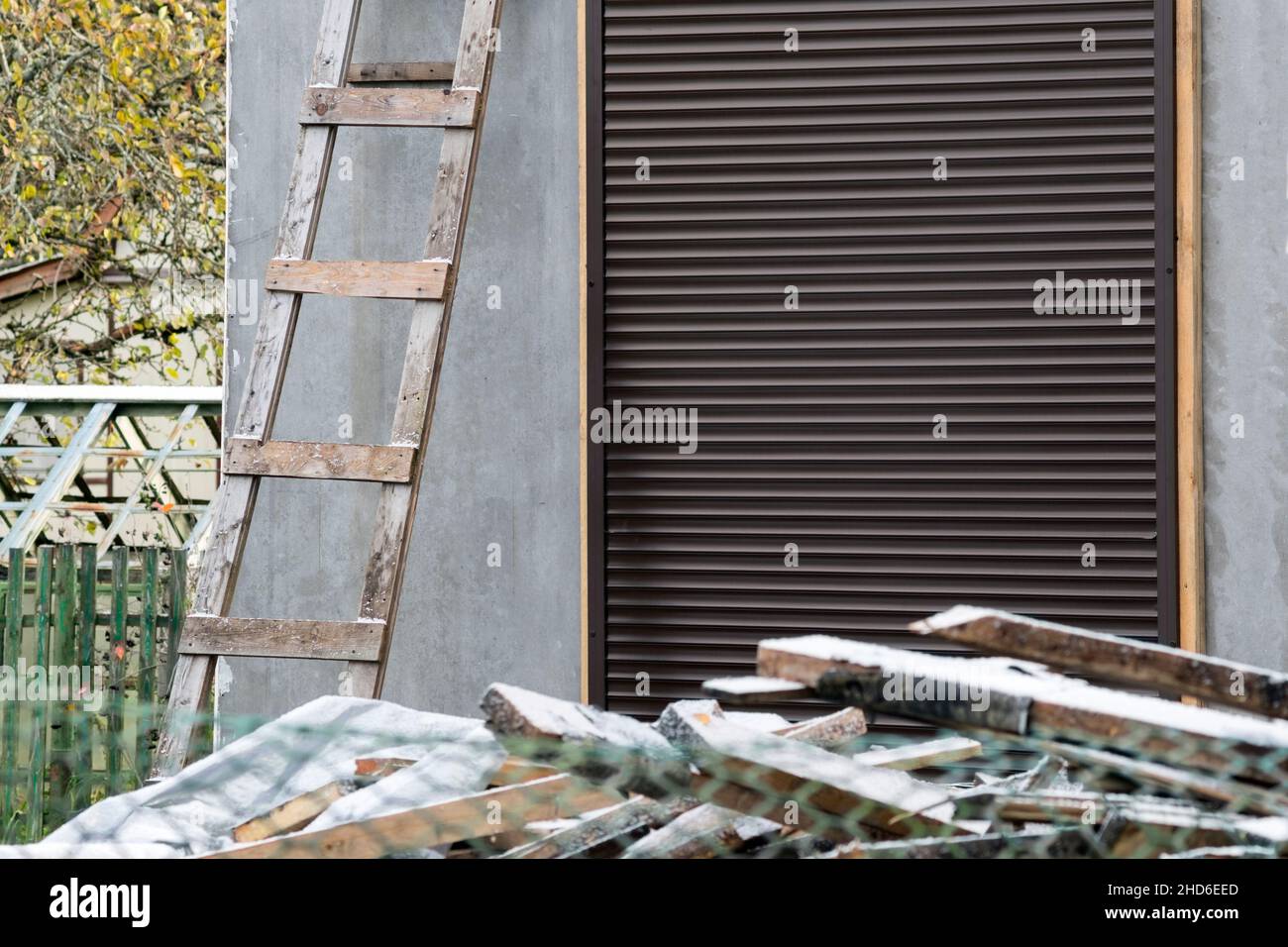 unfinished house protected with metal shutter on entrance door Stock ...