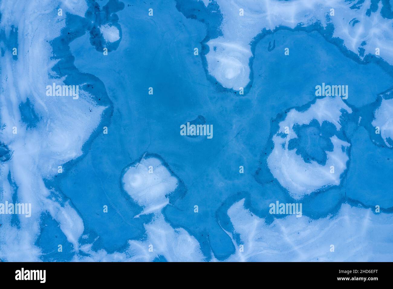 Aerial view of a frozen lake. Abstract blue background. Melting ice ...