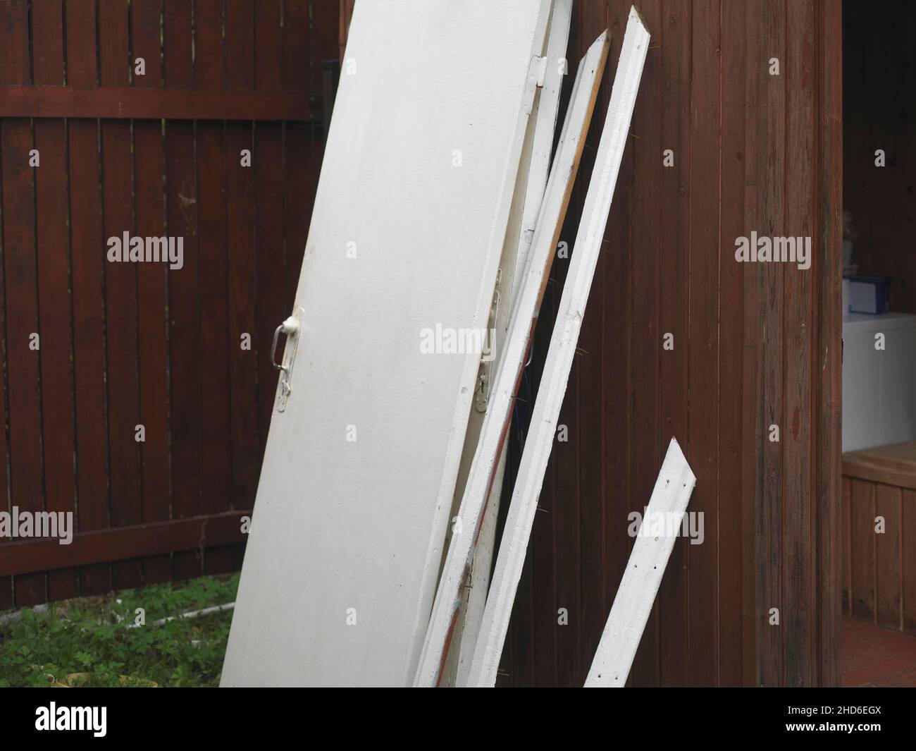 Old discarded wooden door leaning against the wall, outdoor shot Stock ...