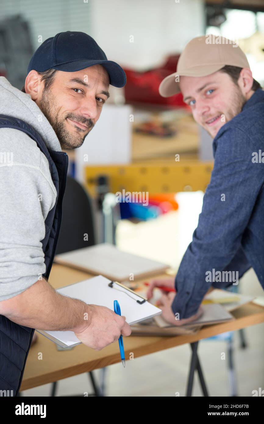 two men wor with wood panels Stock Photo - Alamy
