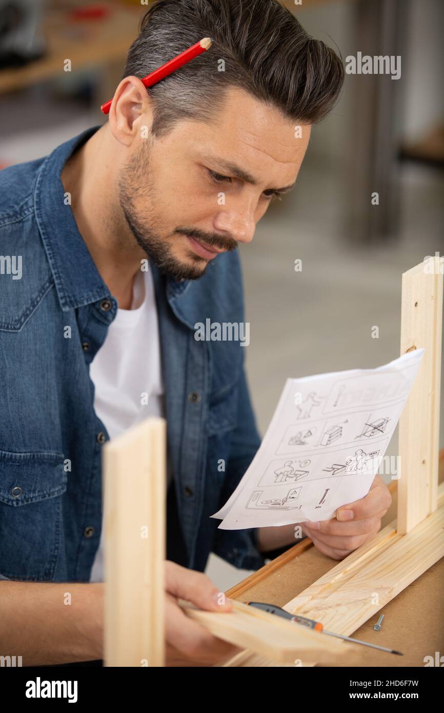 carpenter checking assemble paper manual Stock Photo - Alamy