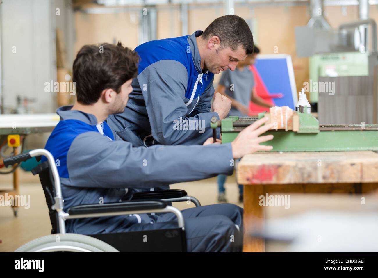 disabled worker in wheelchair in factory on the machine Stock Photo - Alamy