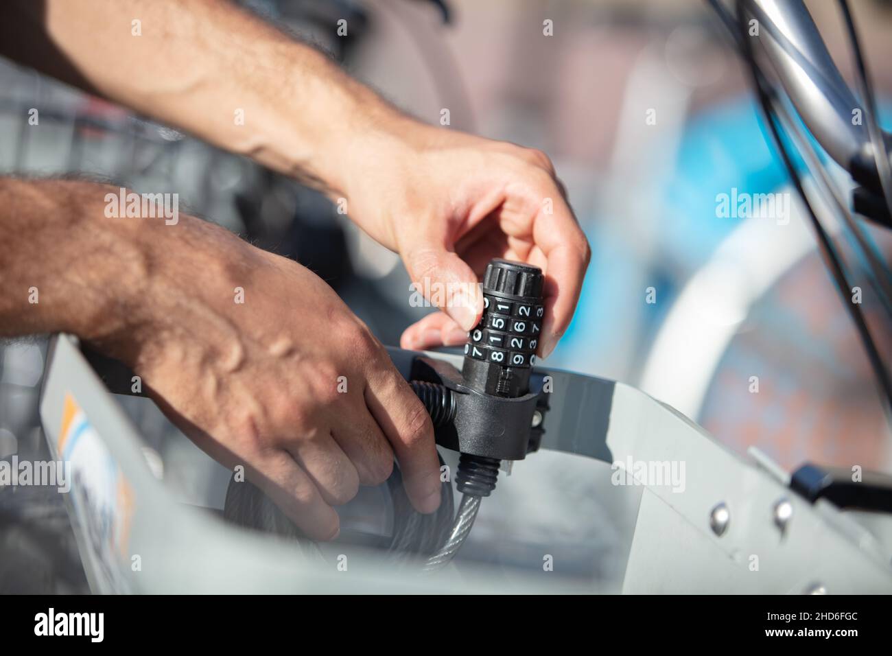 a man clamps a bicycle lock - hands close-up Stock Photo - Alamy