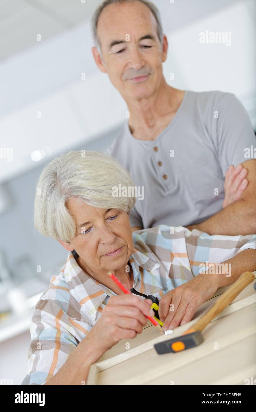 old woman man man fixing an old furniture Stock Photo - Alamy