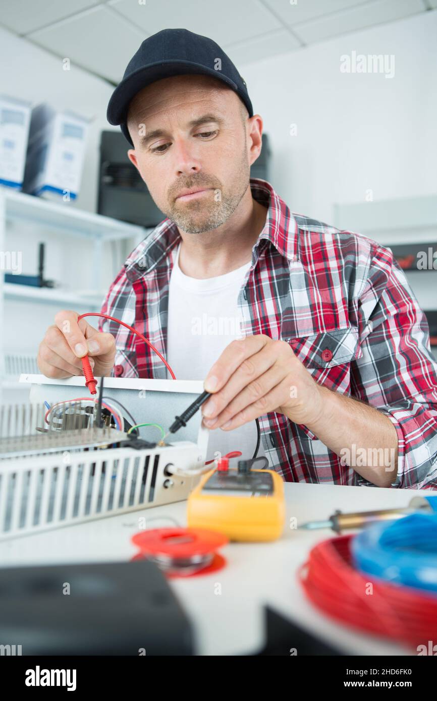 male electrician checking heater with digital multimeter Stock Photo ...