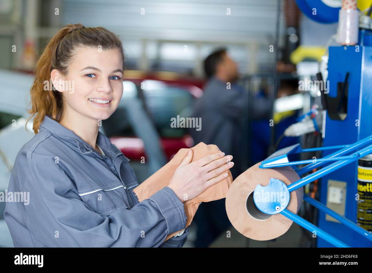 portrait of female mechanic wiping hands with paper towel Stock Photo ...