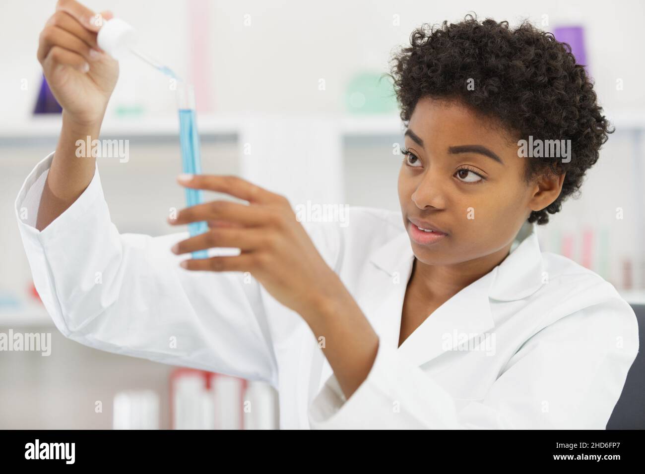 woman works with flask with liquid in a lab Stock Photo - Alamy